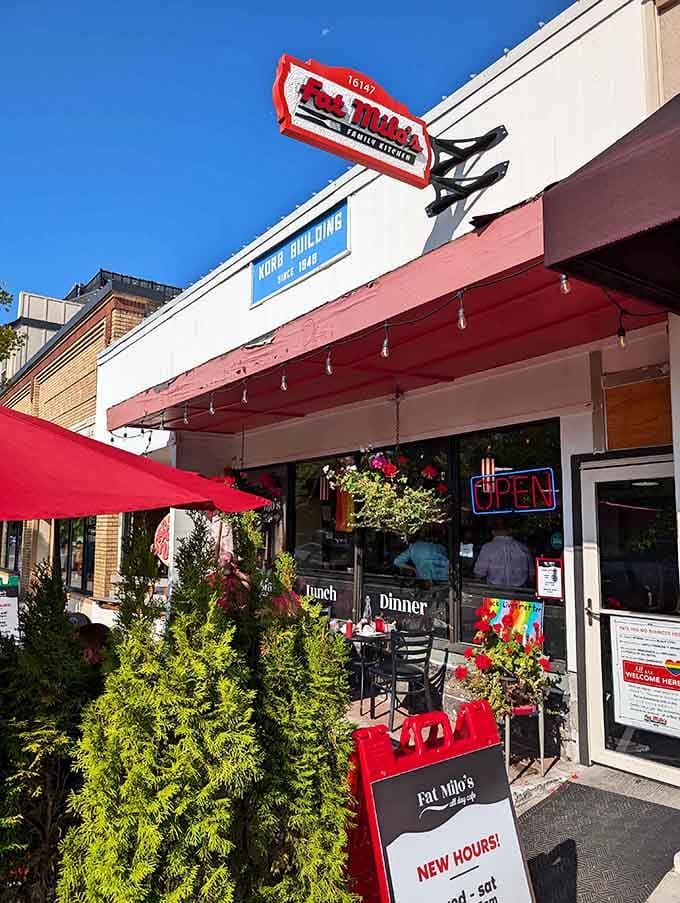 The vintage sign and flower boxes create curb appeal that would make even June Cleaver pull over for breakfast.