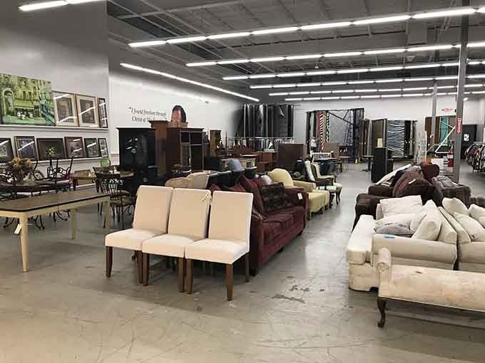 Inside, furniture sprawls across polished floors like a showroom where everything costs pennies on the dollar instead.