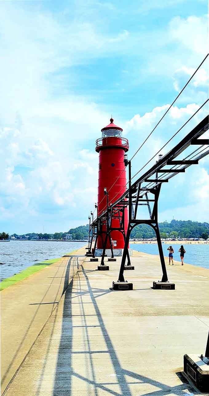 That catwalk stretches like a red ribbon toward adventure, shadows dancing on concrete under summer's brilliant blue sky.