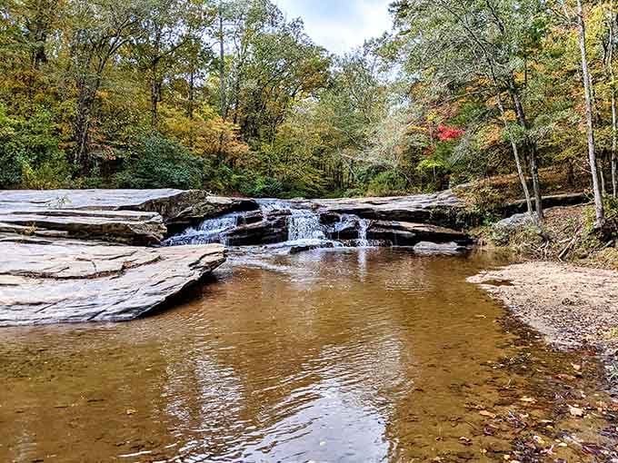 Autumn's paintbrush adds splashes of crimson and gold to this horseshoe-shaped cascade of pure refreshment.