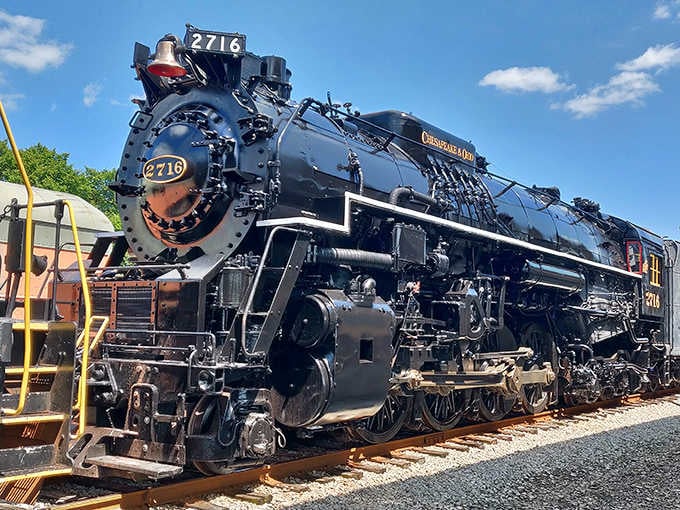 This magnificent steam engine numbered 2716 gleams under blue skies like a polished monument to American industrial craftsmanship.