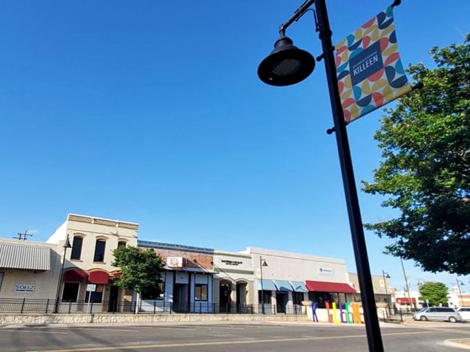 Colorful banners and tree-lined sidewalks add charm to this main street, where local shops invite you to slow down and explore.