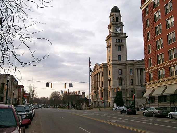 The clock tower rises majestically against moody skies, anchoring downtown with architectural dignity that commands respectful admiration.
