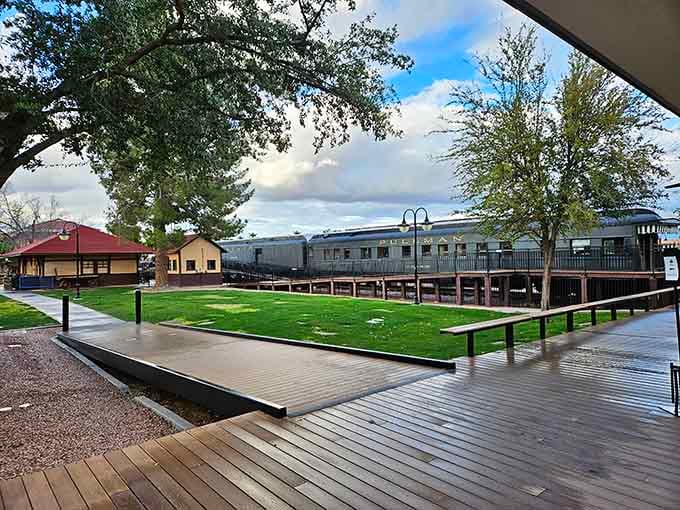 Vintage train cars rest peacefully beside manicured lawns, creating the perfect backdrop for family picnics and childhood dreams.