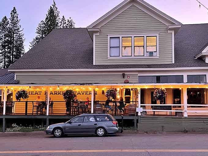 As twilight settles in, those hanging baskets and warm lights create pure small-town dining magic.
