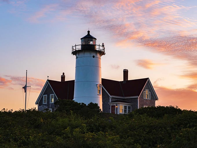 The keeper's cottage sits cozy beside the tower, looking like the perfect retirement dream for any lighthouse enthusiast.