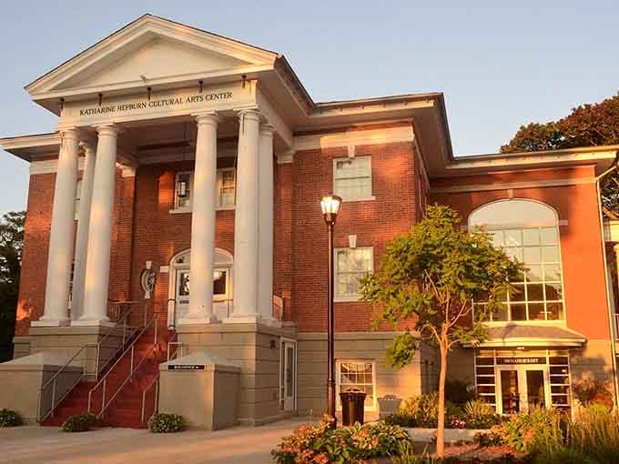 The Katharine Hepburn Cultural Arts Center glows in golden hour light, bringing Broadway-caliber shows to the shoreline.