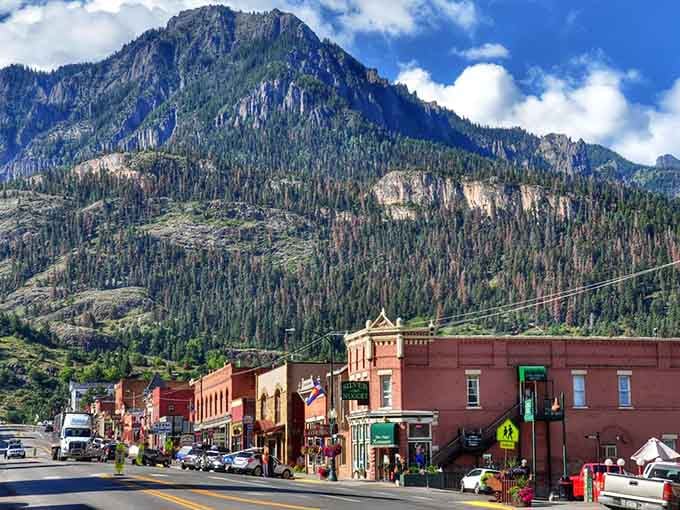 Mountains wrap around these colorful storefronts like nature's own protective embrace, creating Switzerland in Colorado.