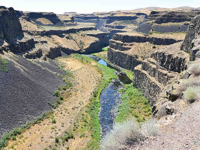 From above, the canyon's dramatic layers unfold like pages in Earth's ancient geological storybook below.