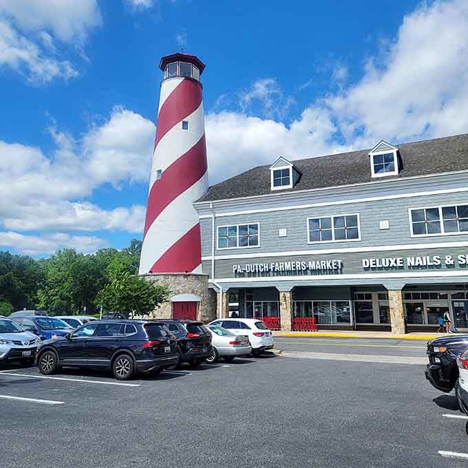 That magnificent lighthouse stands proud against blue skies, guiding shoppers to fresh foods and handcrafted treasures below.