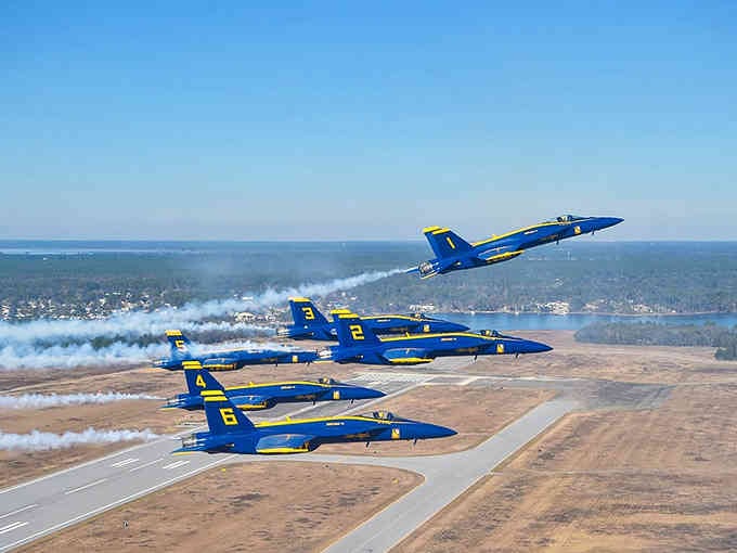 The Blue Angels soar in perfect formation, painting the sky with precision that takes your breath away.