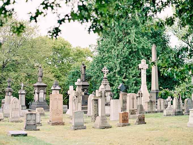 Victorian monuments rise like silent sentinels among the graves, their ornate details speaking to an era of elaborate remembrance.