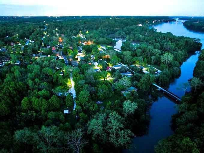 Evening light turns this riverside retreat into a glowing sanctuary where trees outnumber people by a comfortable margin.