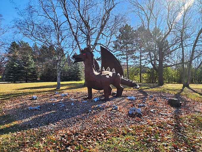 Fallen leaves carpet the ground around this gentle dragon, creating a scene straight from a storybook.
