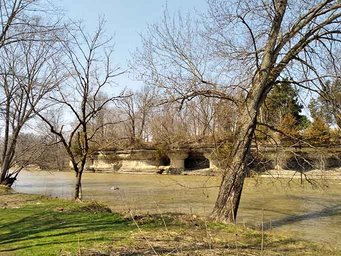 Nature's architecture reveals itself in these weathered stone columns that have witnessed countless seasons pass by their shores.