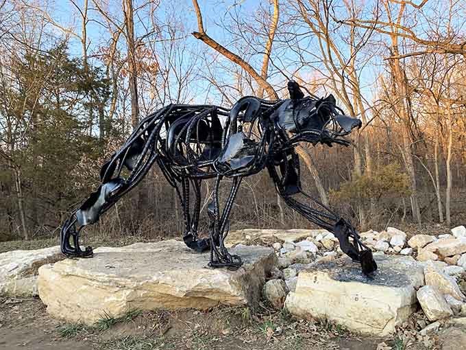 This sleek black sculpture of a prowling cat radiates power and grace, muscles tensed like it's stalking invisible prey.