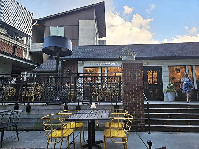 Those bright yellow chairs pop against the brick, creating an Instagram-worthy spot for your next meal.