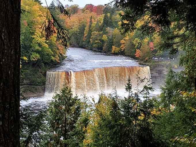 Autumn frames this thundering waterfall in nature's most vibrant colors, a masterpiece painted fresh each fall season.