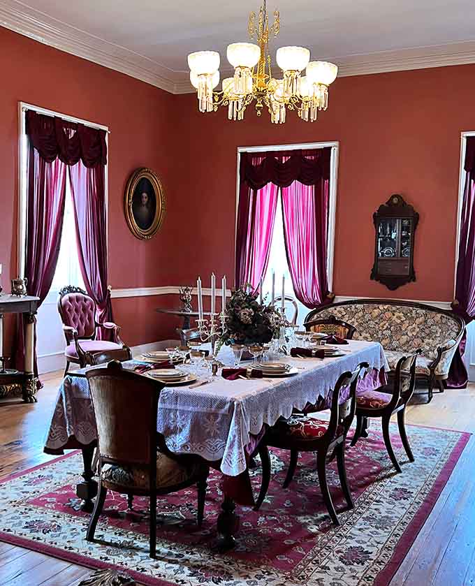 That formal dining room with its rich colors and crystal chandelier practically begs for a dinner party, spirits optional.