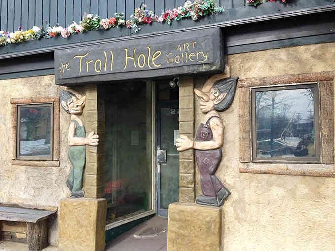Two carved troll guardians flank the entrance to this quirky gallery, promising treasures and wild-haired wonders waiting inside for visitors.