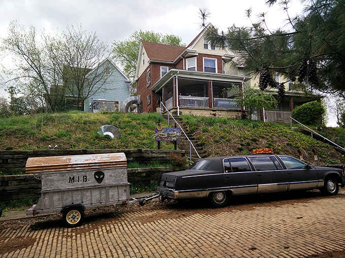 A vintage hearse and quirky trailer hint at the wonderfully strange collection waiting inside this hillside manor.
