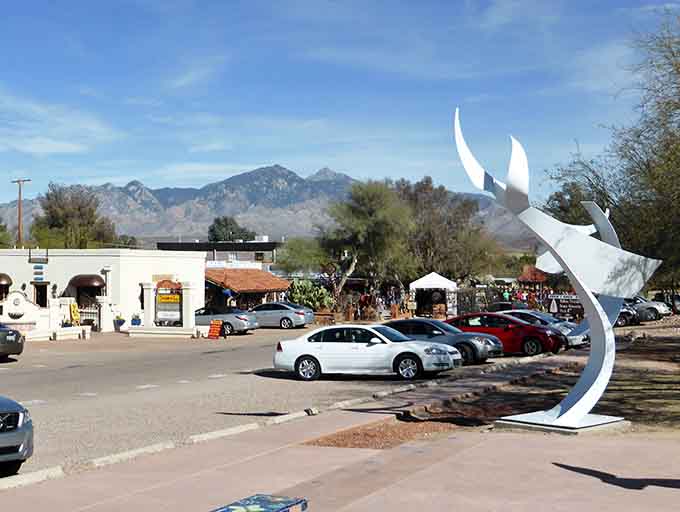 That striking white sculpture against blue sky captures the artistic spirit that makes this village so special.