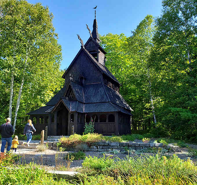 Dark timber and dragon heads rise from the forest like something straight out of a Viking legend come alive.