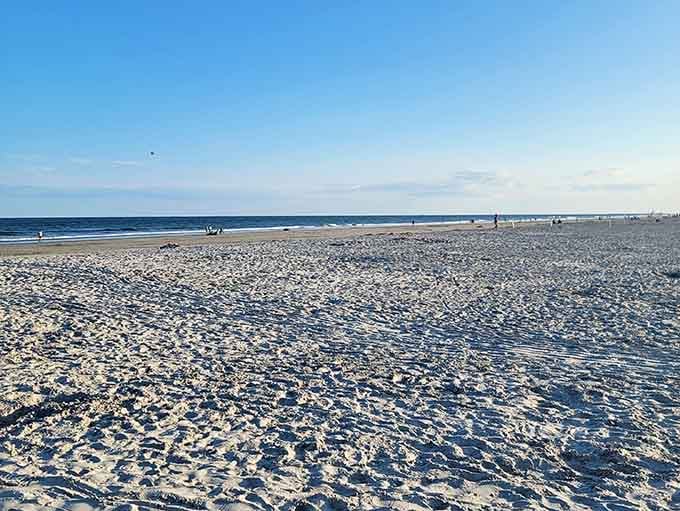 Miles of pristine sand meet calm waves under open skies&mdash;nature's reminder that simple pleasures cost nothing.