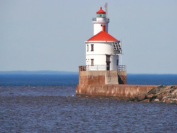 The bright red cap on this cylindrical tower makes it look like a giant lipstick tube marking safe passage home.