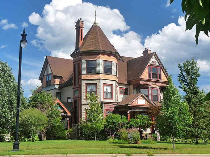 Victorian elegance stands proud with its turret and gables, like a wedding cake that never goes out of style.