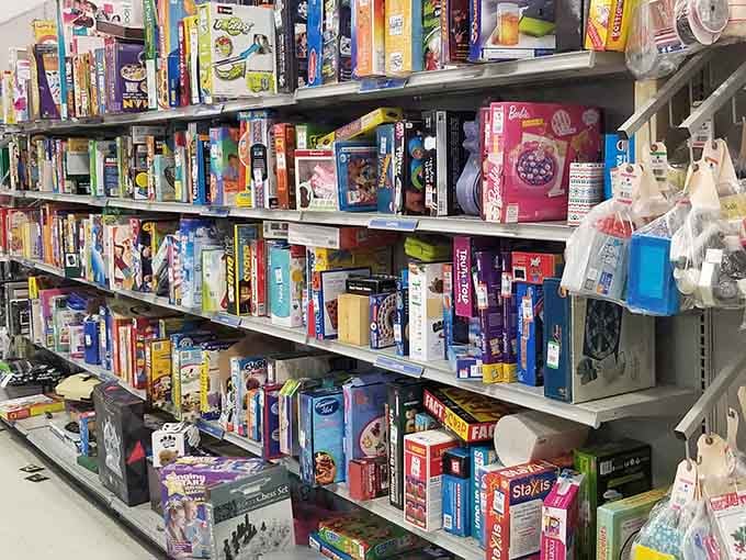 Board games and puzzles stacked like they're auditioning for the world's most entertaining garage sale.