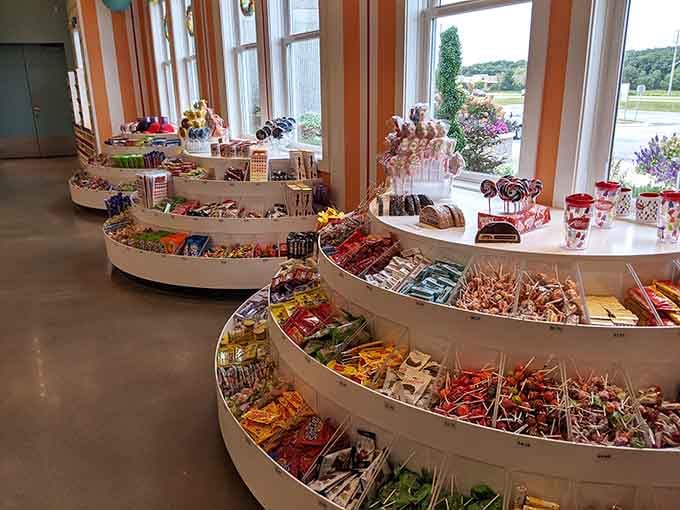 Curved display shelves showcase an embarrassment of candy riches, from lollipops to chocolate-covered everything your heart desires.