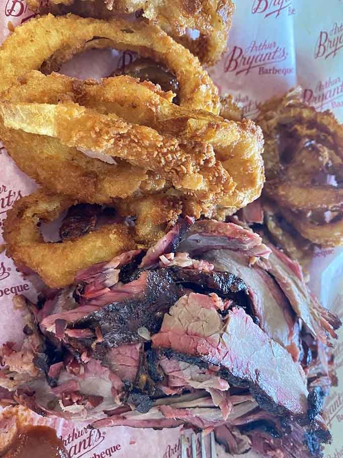 Golden onion rings piled next to smoky brisket is the kind of combination that makes you believe in destiny.