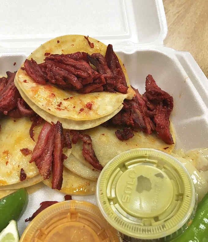 Perfectly stacked corn tortillas loaded with meat that's been treated with respect, ready for your commute home.