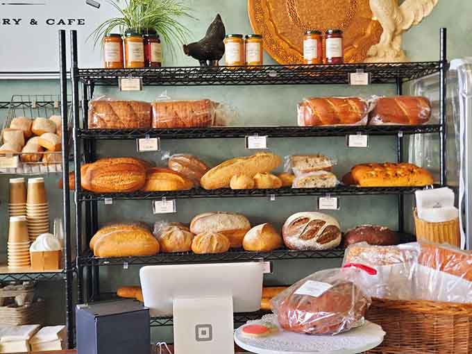 Shelves of fresh-baked bread arranged like edible architecture, each loaf begging to be taken home immediately.
