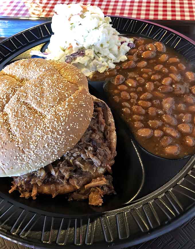 That pulled brisket sandwich on a sesame seed bun is basically a love letter to your taste buds.