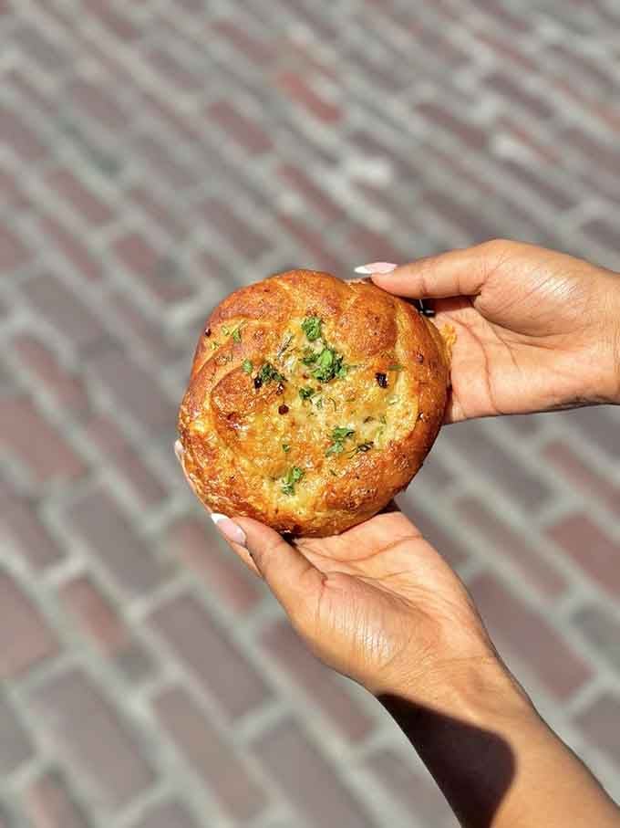 Golden, crispy, and studded with herbs, this cheese bread could make a grown person weep with joy.