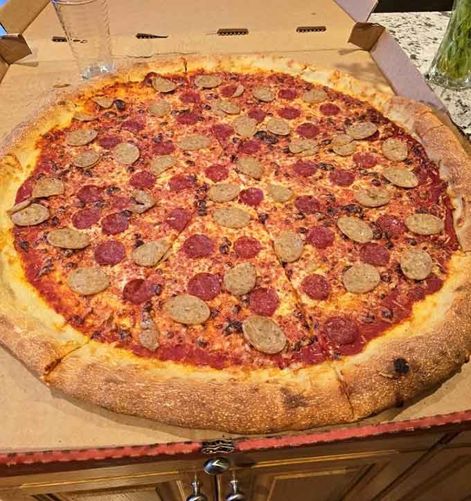 That pepperoni and sausage combo sprawls across the plate like it's claiming territory, and you're not complaining.