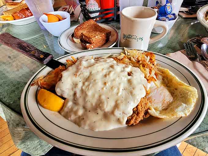 That chicken fried steak buried under country gravy is basically a warm hug on a plate with eggs.
