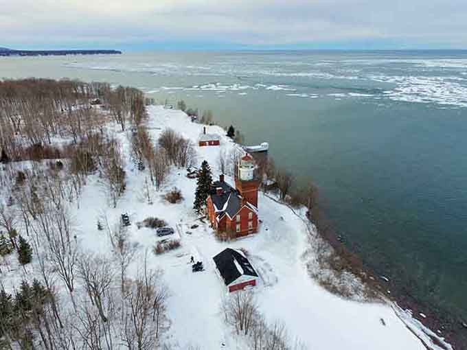 Winter transforms the lighthouse into a Currier and Ives print, proving Michigan's cold season has serious aesthetic game.