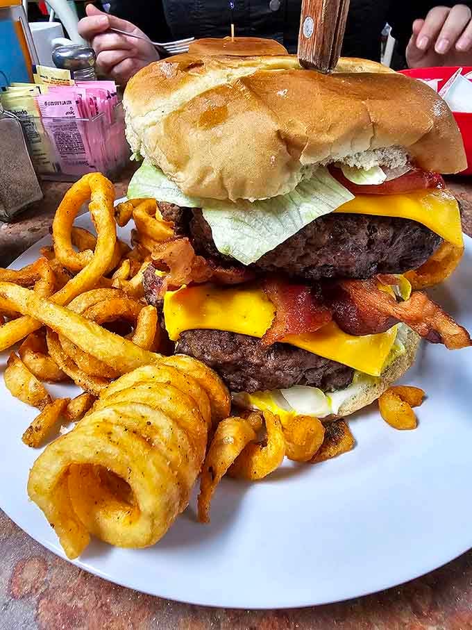Two patties, bacon, cheese, and a bun doing its absolute best to hold everything together somehow.