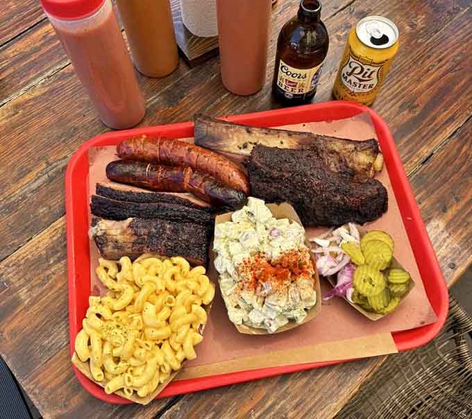 This tray of smoky perfection includes brisket, ribs, sausage, and sides that complete the Texas barbecue dream.