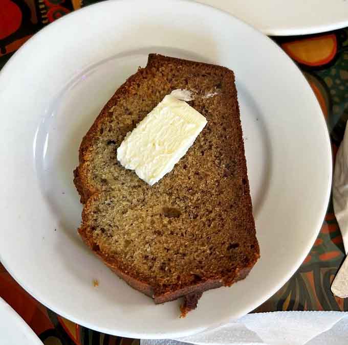 Warm banana bread with butter melting into every crumb, proof that simple pleasures are usually the best ones.