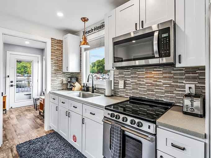 This galley kitchen packs serious style with its mosaic backsplash and modern appliances, perfect for morning coffee rituals.