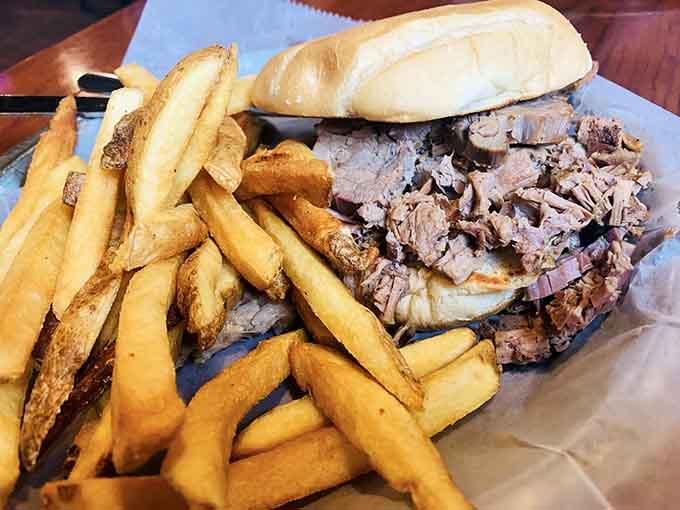 When brisket piles this high on ciabatta, you're looking at commitment on a plate with fries for backup.
