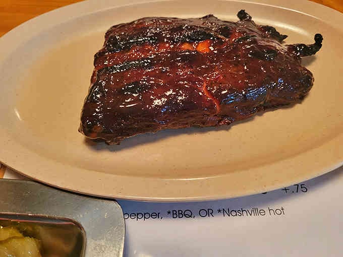 Those ribs wear their glaze like a badge of honor, glistening with the kind of perfection that demands napkins.