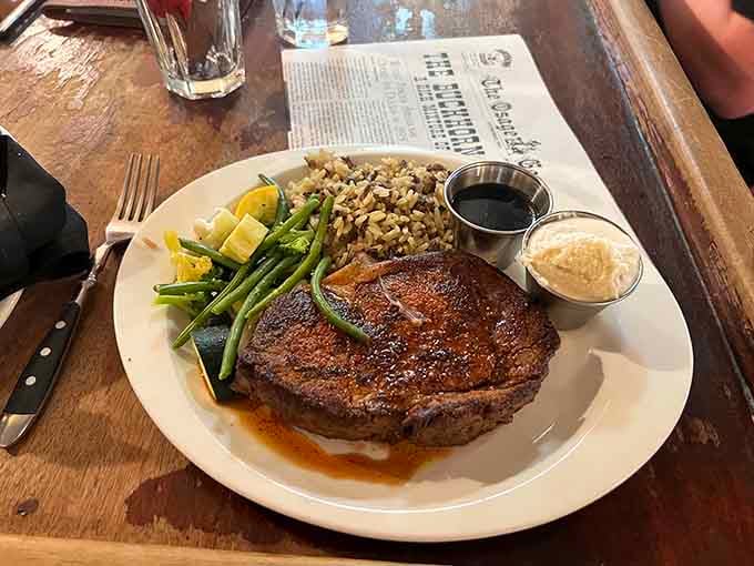 That perfectly seared steak with wild rice and green beans is what happens when Old West meets culinary excellence.