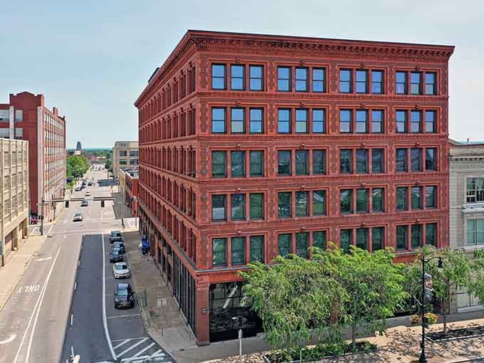 Red brick industrial elegance meets contemporary urban living in buildings that remember when craftsmanship actually mattered to builders.