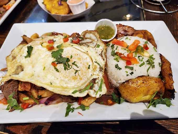 Lomo saltado brings Peruvian flair to your plate with stir-fried beef, peppers, and the genius combination of rice and fries.