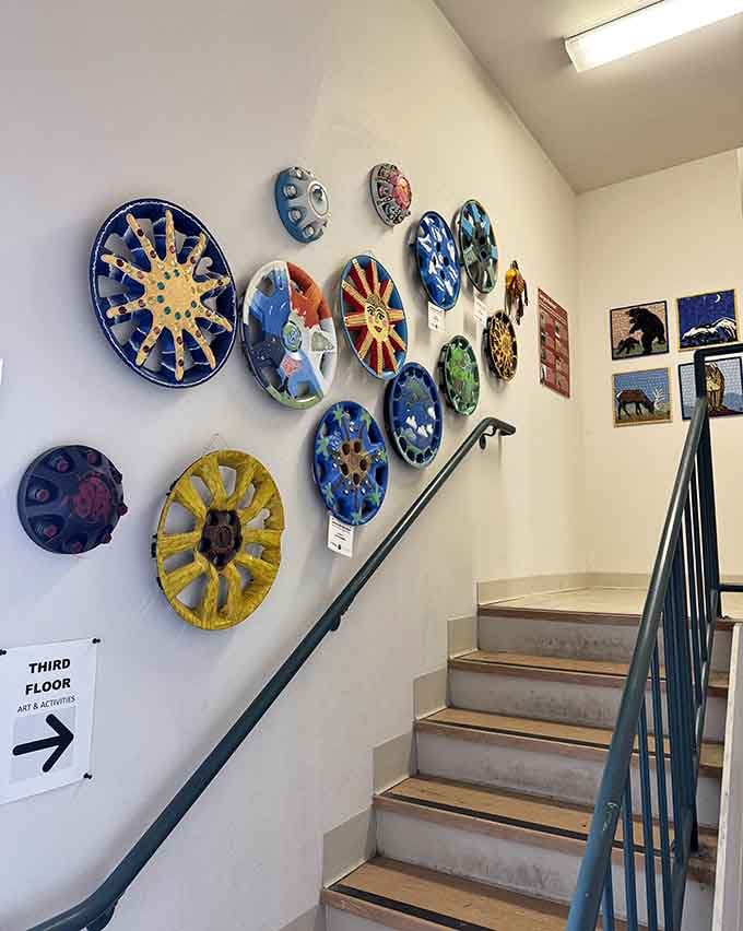 Colorful circular artworks line the stairway, adding vibrant personality to every level of the museum.